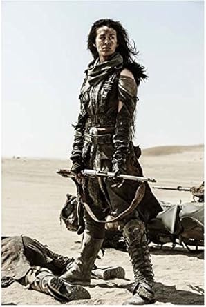 Courtney Eaton as Cheedo the Fragile holding a rifle as she stands over ...