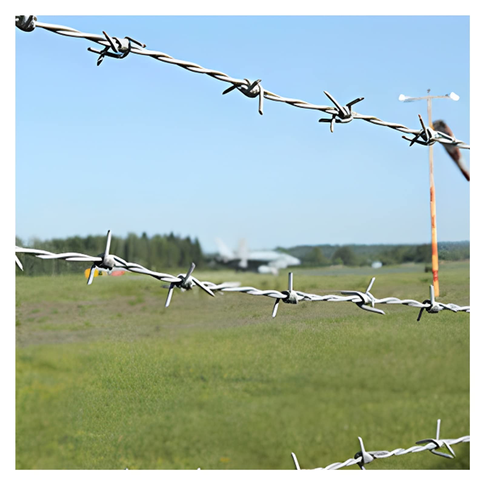 Barbed Wire Fence On Farm