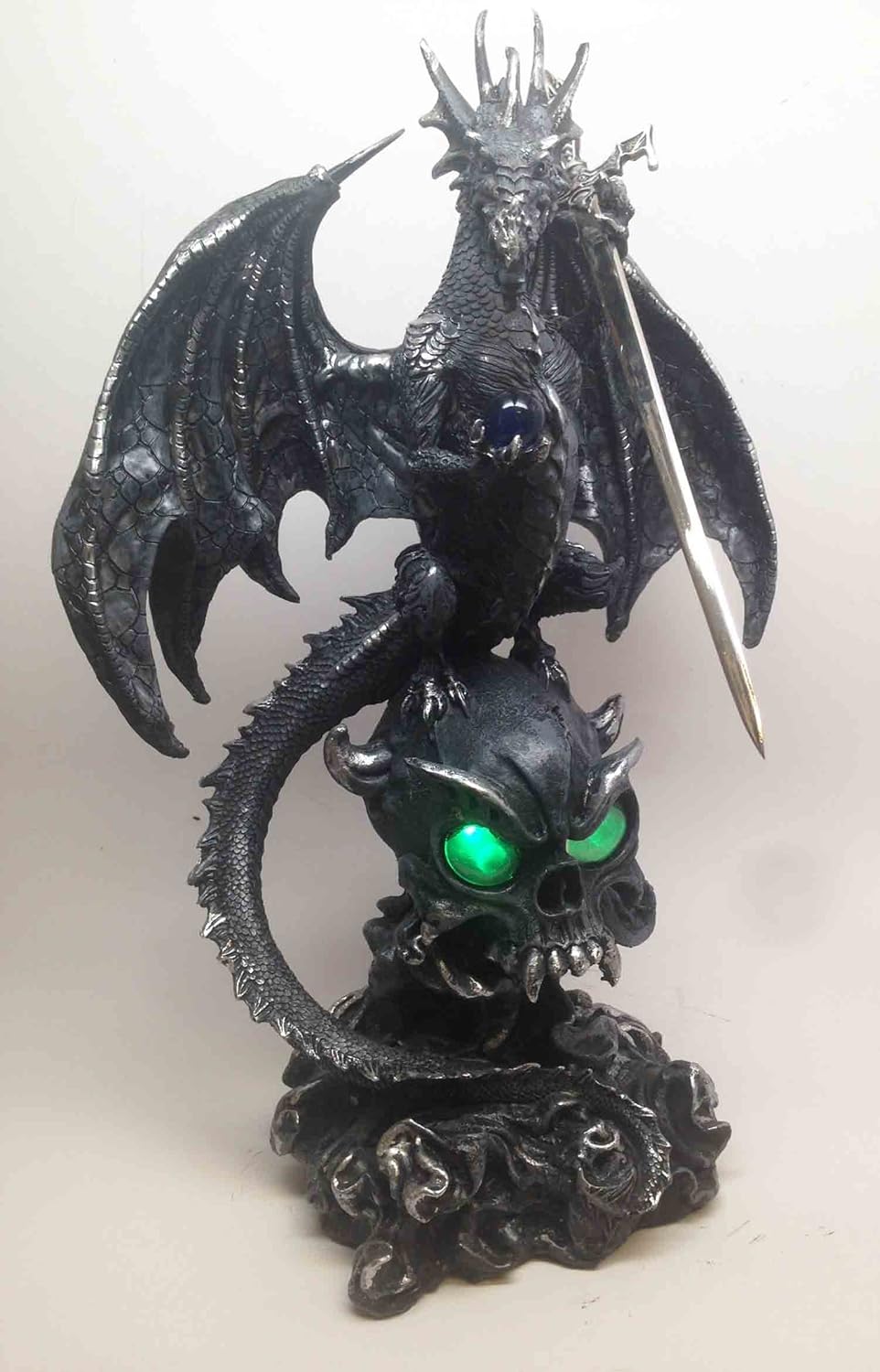 Amazon.com: LARGE GRENDEL DRAGON HOLDING SWORD ON SKULL WITH LED EYES ...