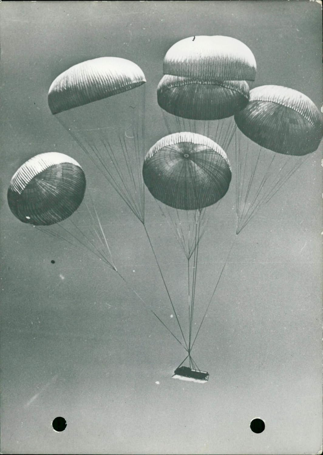 Six large parachutes guide a 2 and a half ton truck to the ground ...