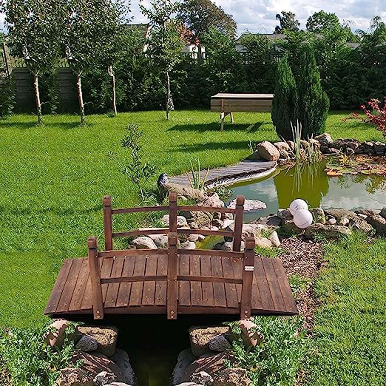 Koi Pond With Bridge Koi Pond In The Garden At The Foot Of The Hotel