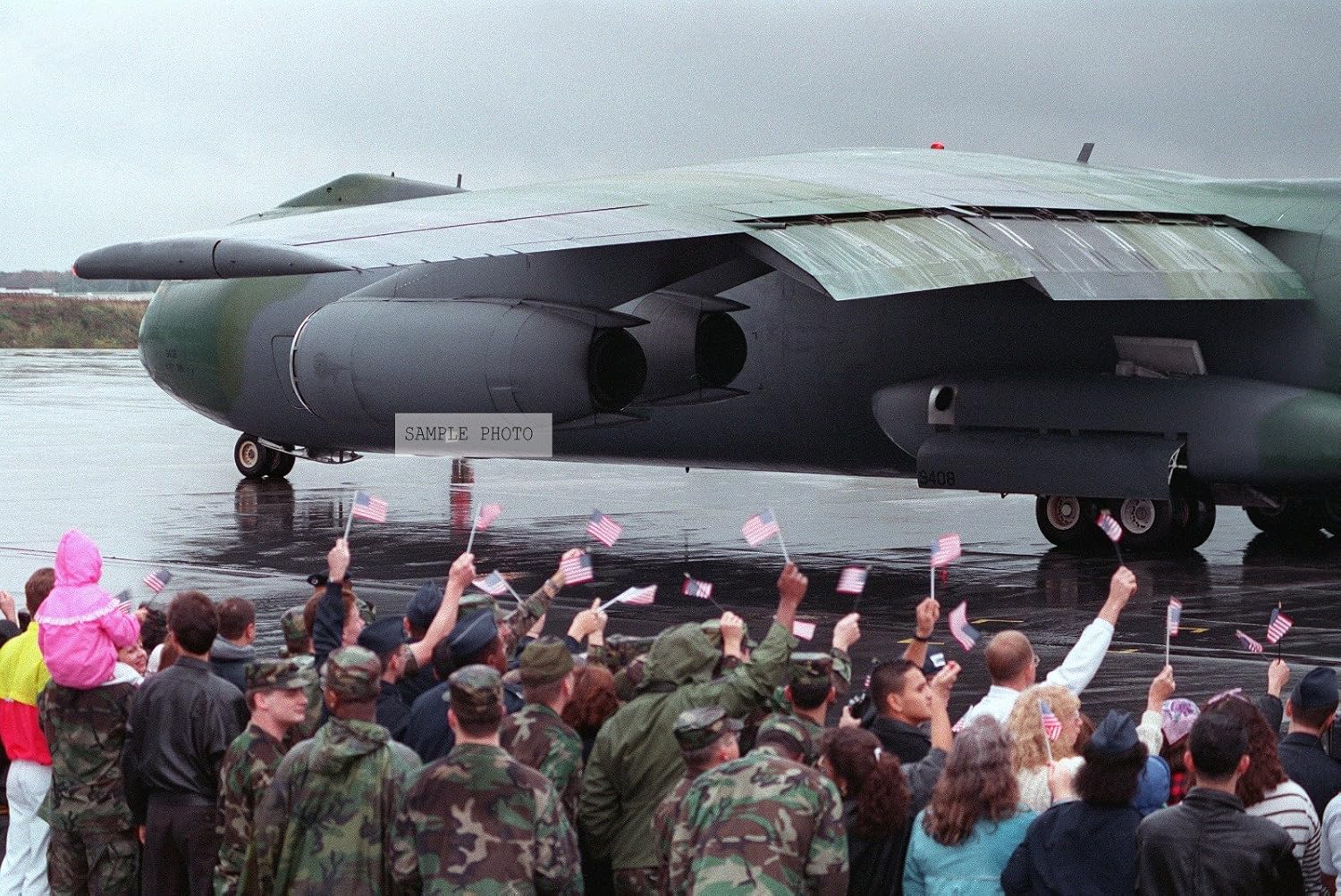 Amazon.com: Photo Crowd in the foreground wave flags as an aircraft ...