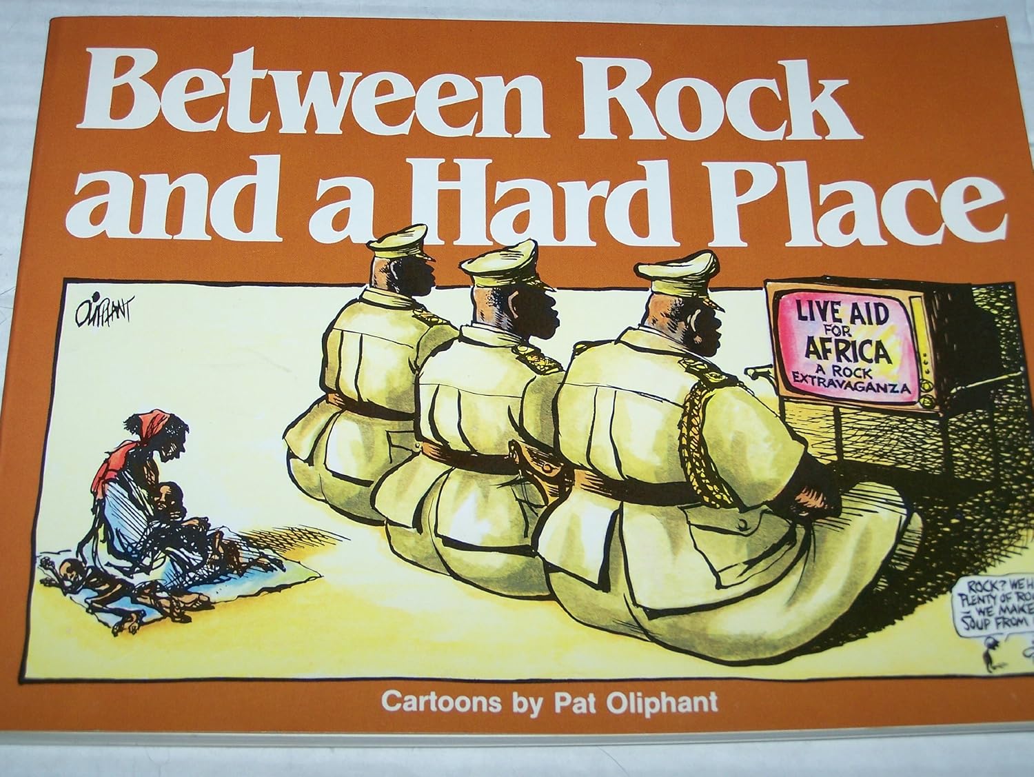 Between A Rock And Hard Place: Oliphant: 9780836220841: Amazon.com: Books